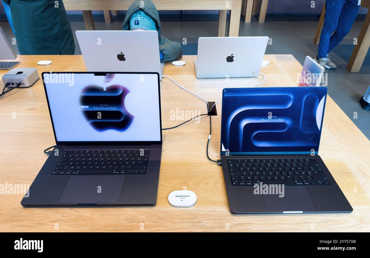 Paris, France - Dec 10, 2024: Two MacBook Pro laptops with vibrant ...
