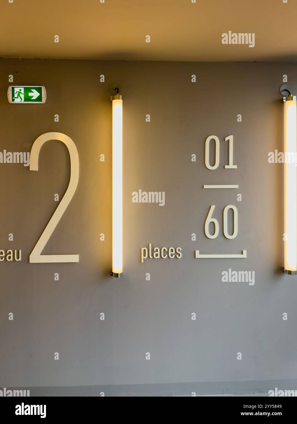 Gray wall displaying illuminated parking level signage with bright ...