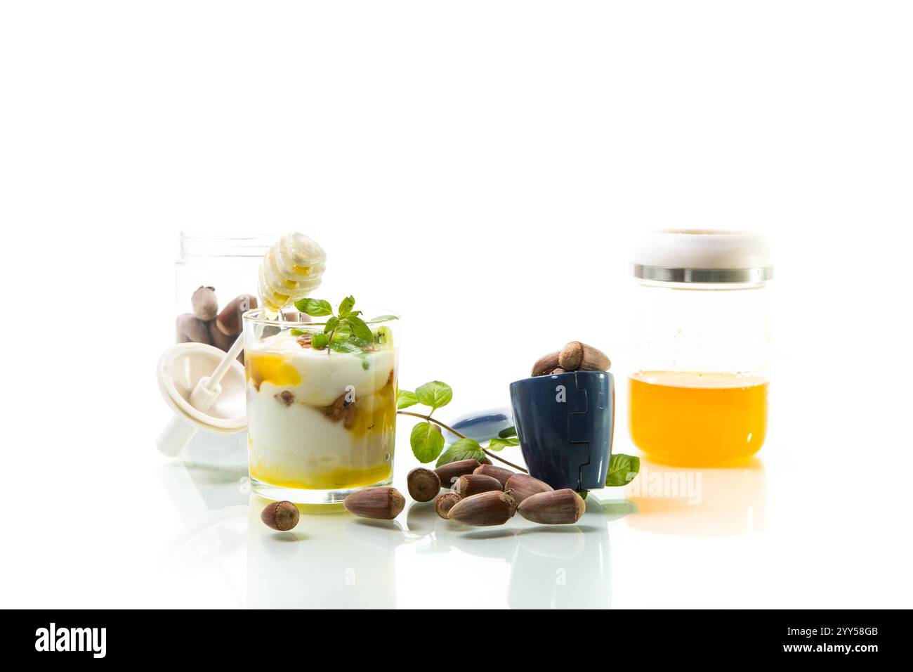 homemade yogurt with kiwi, honey and nuts in a glass, isolated on white ...