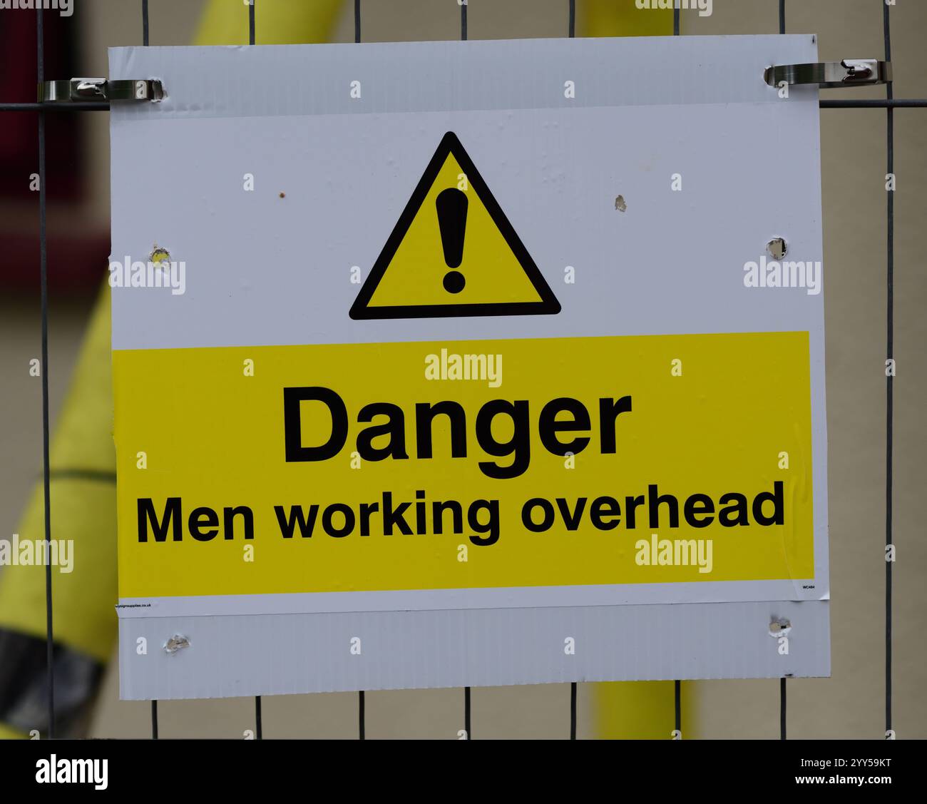 A sign warning about men working overhead Stock Photo - Alamy