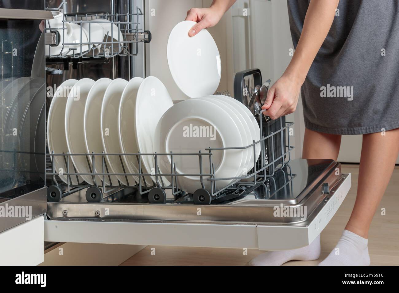 Female hand unloading dishwasher hi-res stock photography and images ...