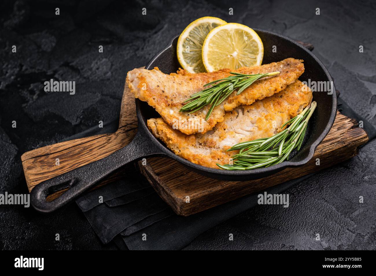 Pan Fried Hake white fish fillet. black background. top view Stock ...