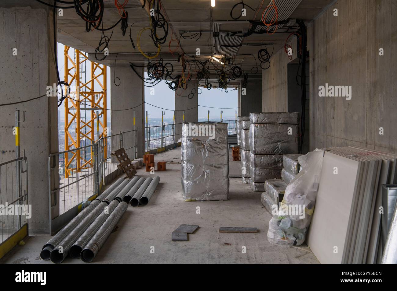 interior of skyscraper floor under construction. Cables, pipes and ...