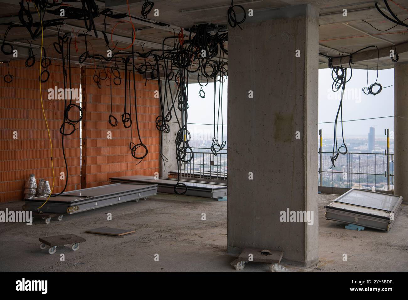 interior of skyscraper floor under construction. Cables, pipes and ...