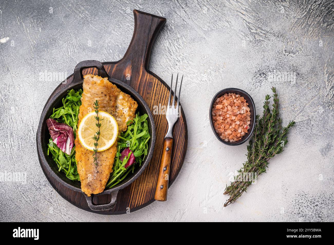 Fried Haddock fish fillet in a pan. grey background. top view Stock ...