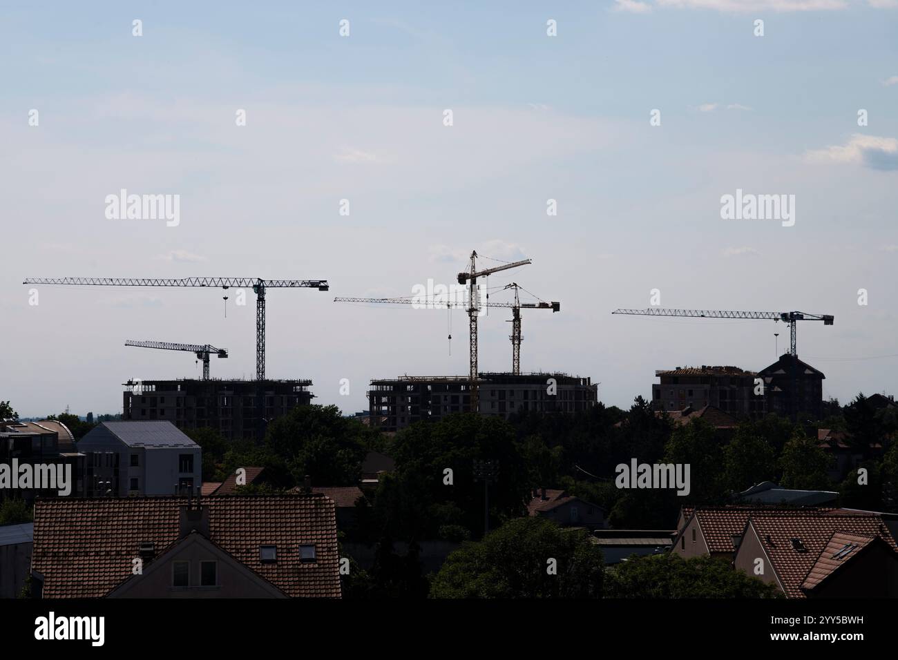 Industrial zone background with construction cranes silhouettes over ...