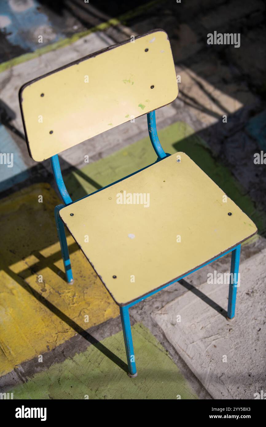 Old wooden empty yellow school chair on colorful concrete blocks Stock ...
