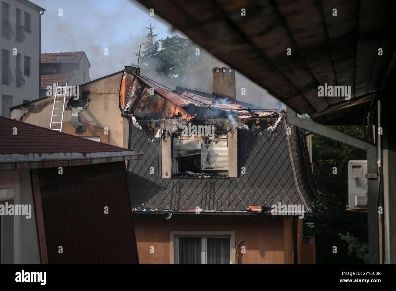 Rooftop of residential housebuilding on fire and burning down. Burning ...