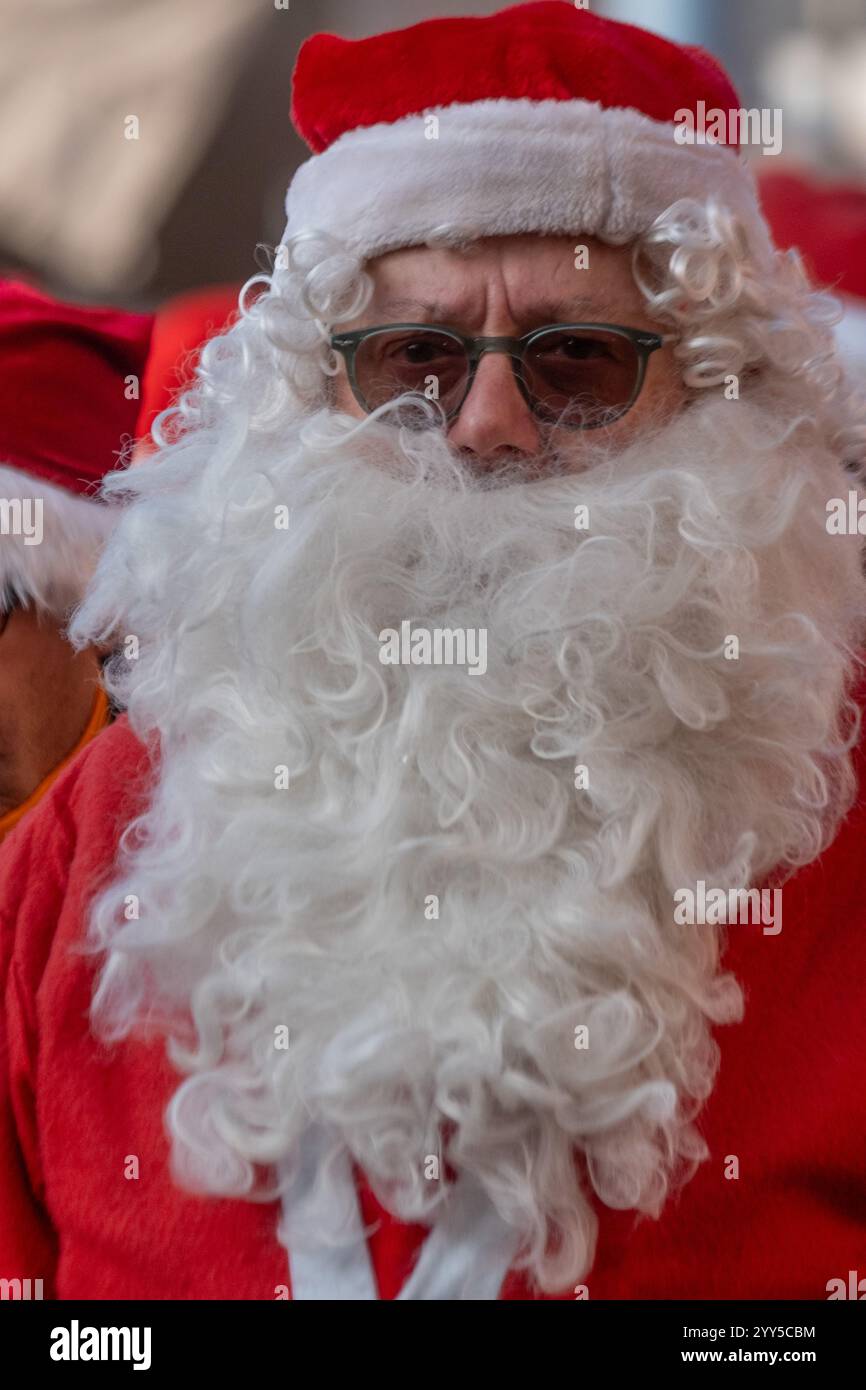 Runners pass by the ‘Rocca dei Tempesta’ during the traditional Santa ...