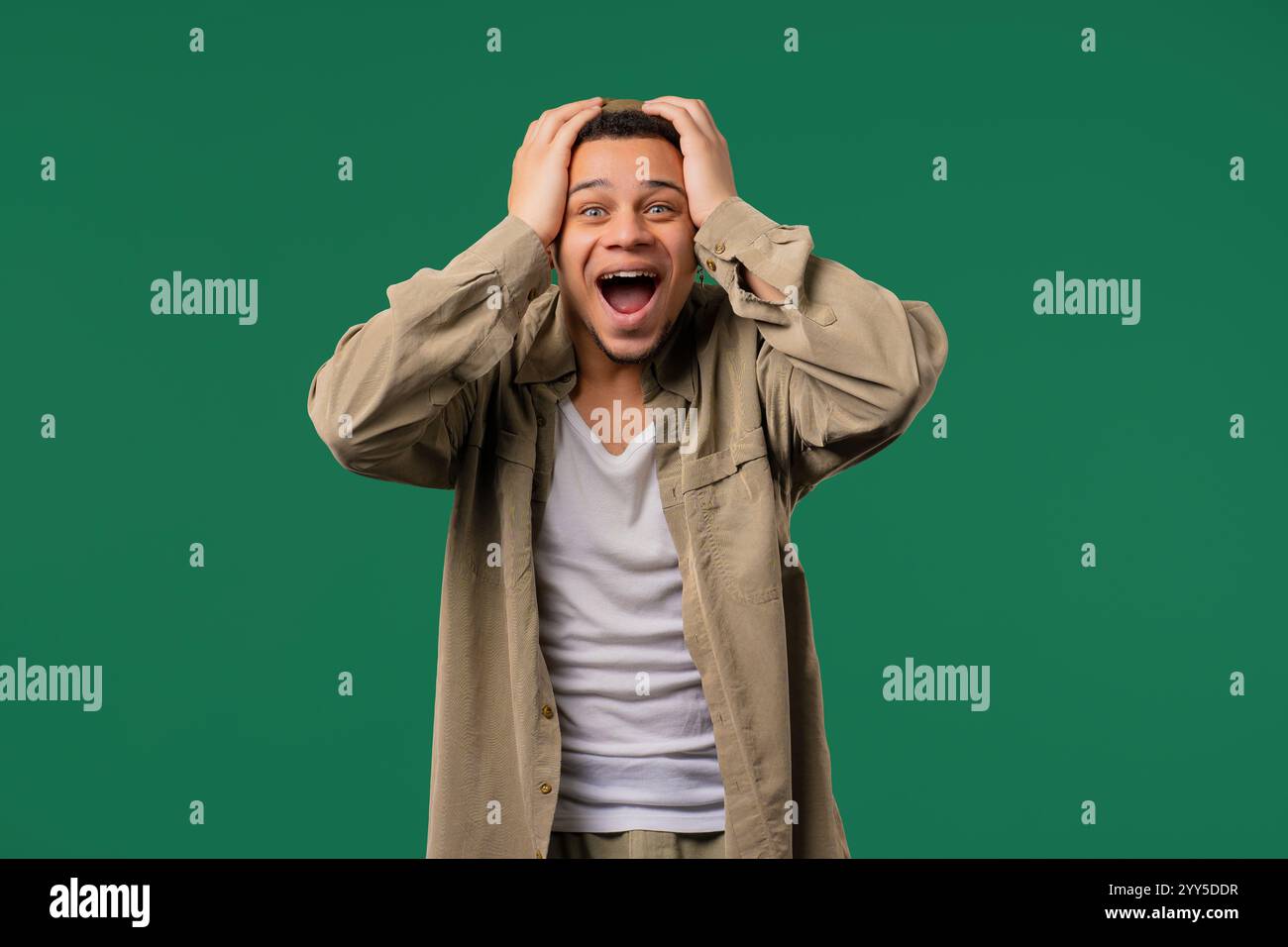 Shocked african american man glad, screaming WOW. Impressed guy ...
