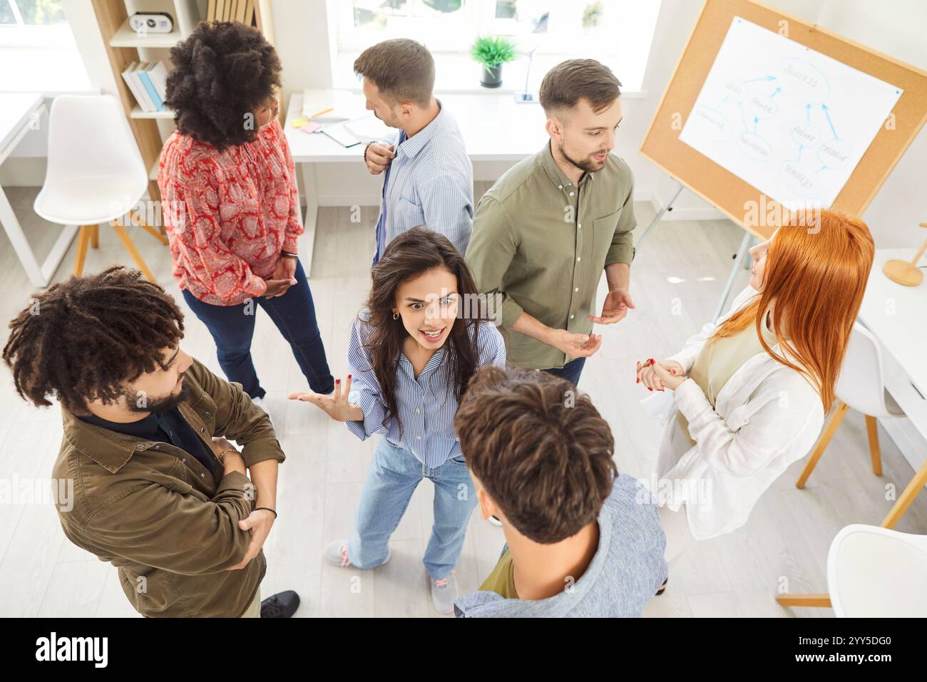 Group of company employees standing in office, discussing strategy ...