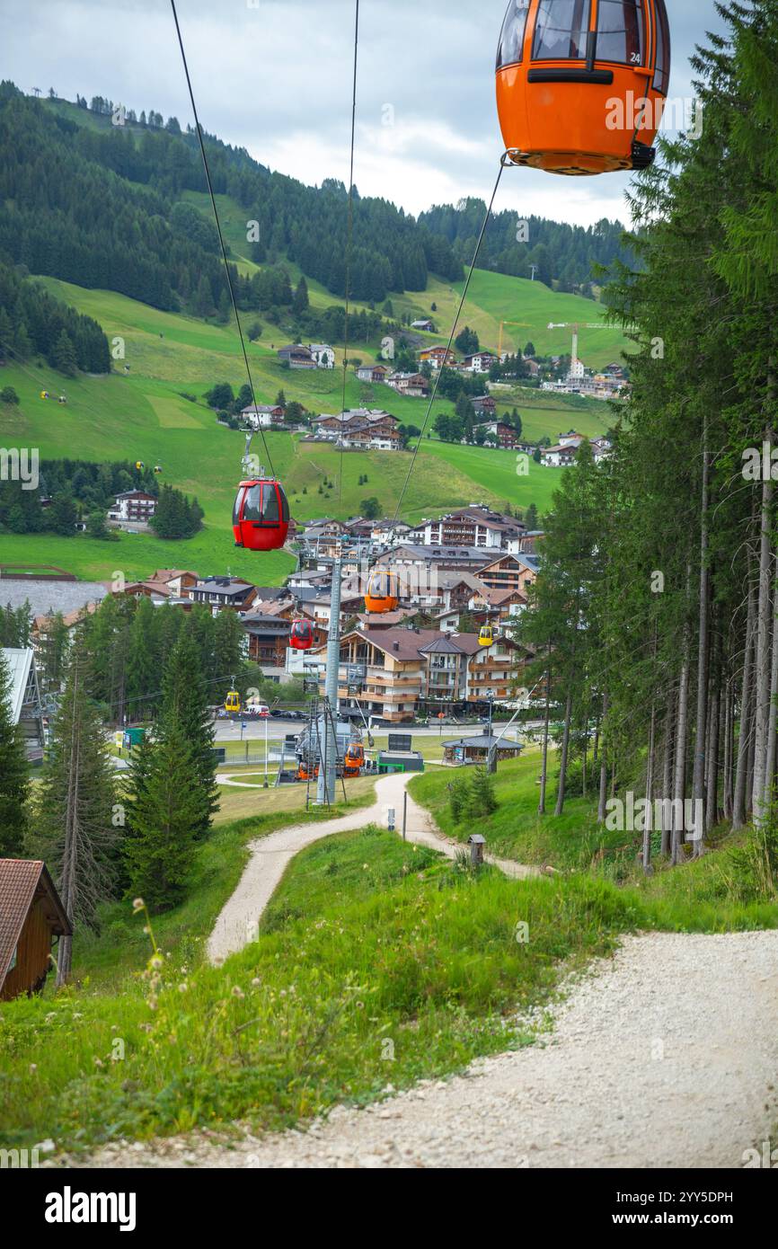 the cable car moving towards the village Corvara, Dolomites, Italy ...