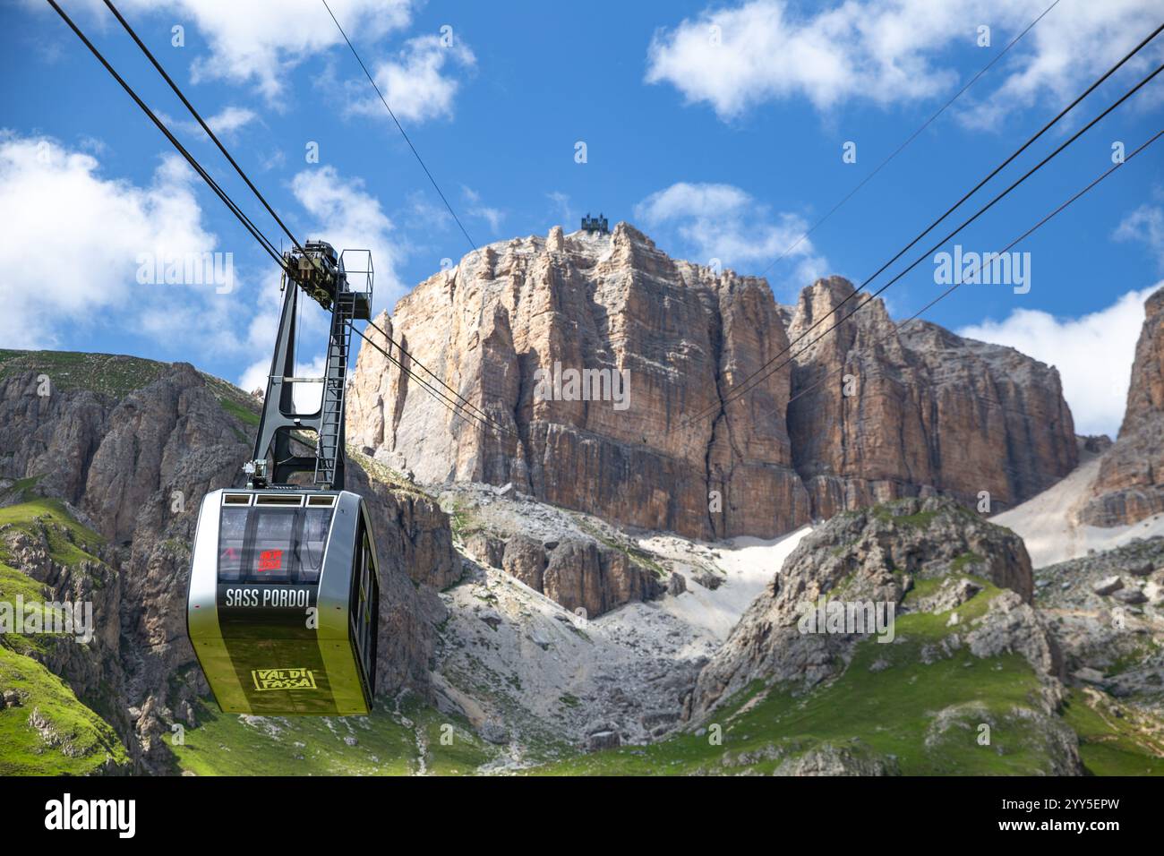 Dolomites, Italy---July 29, 2024: Sass Pordoi cable car moving up to ...