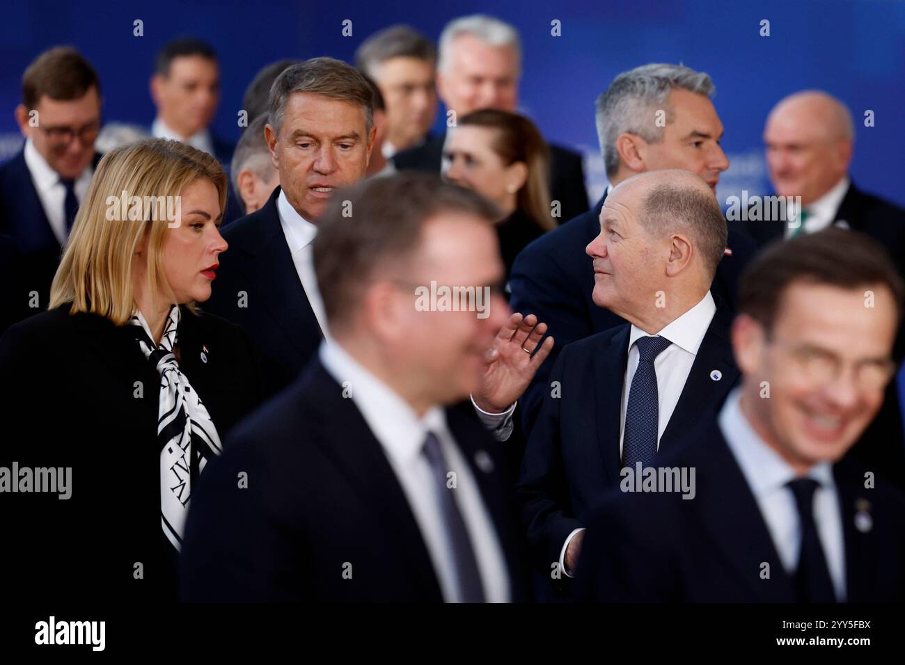 Germany's Chancellor Olaf Scholz, third right, speaks with Romania's ...