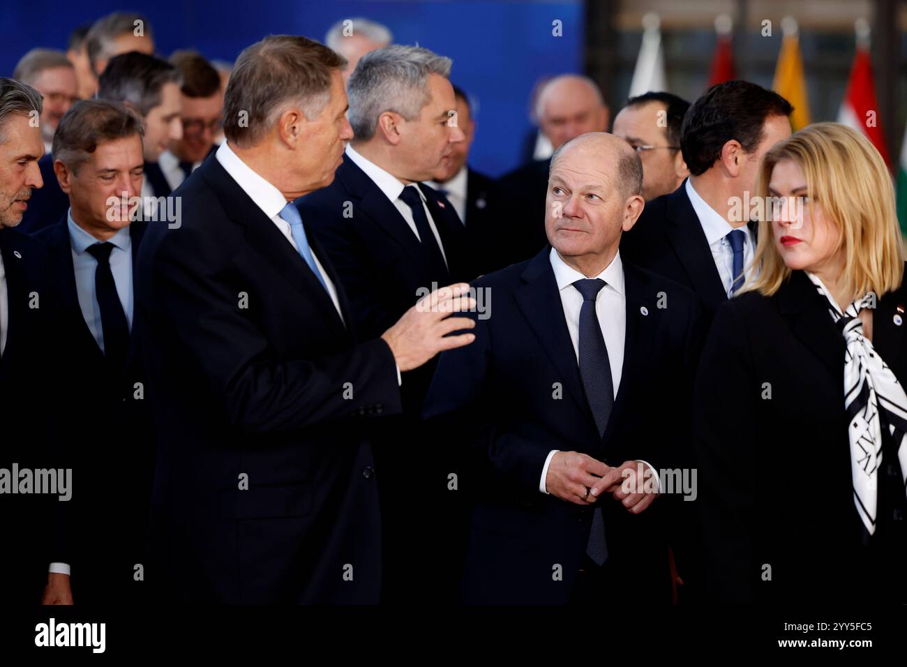Germany's Chancellor Olaf Scholz, third right, speaks with Romania's ...