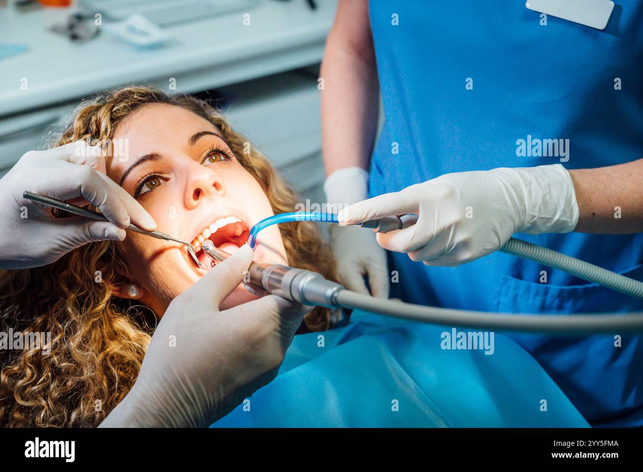 Dentist doing dental cleaning Stock Photo - Alamy