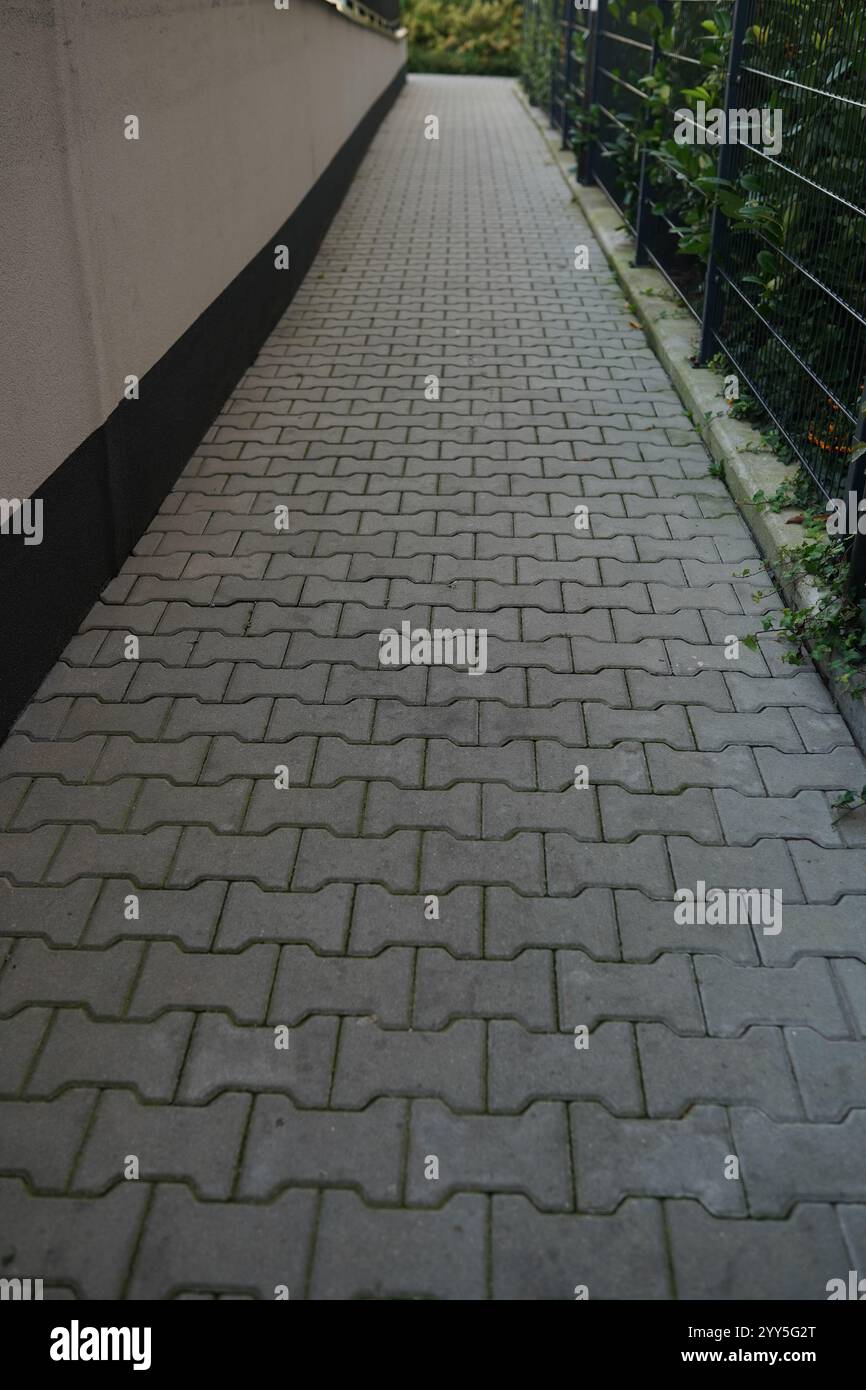 A close-up view of concrete pavement surface, showcasing interlocking pavers arranged in a ...