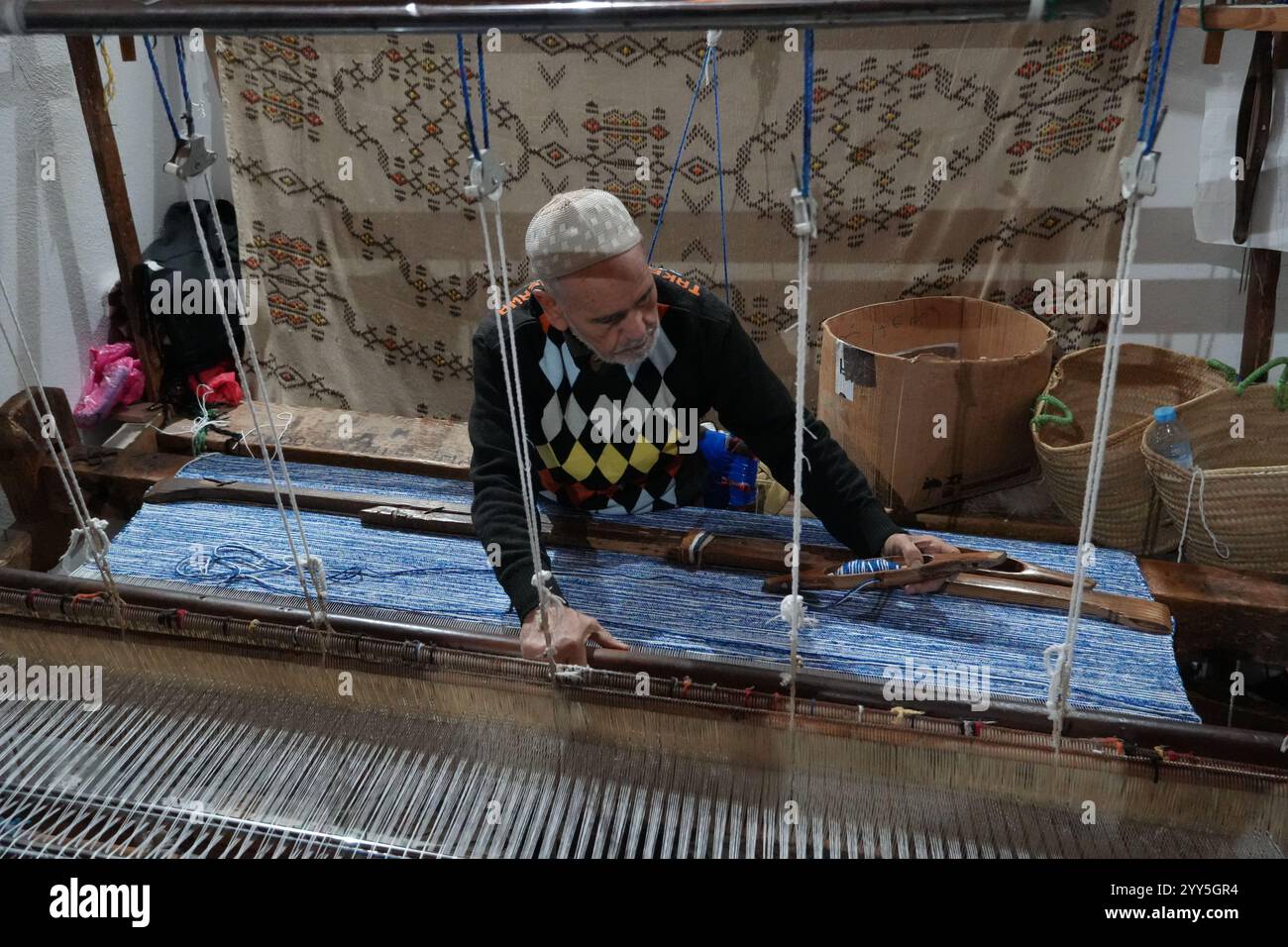 Weaver working on his loom in the Moroccan city of Chefchaouen, North ...