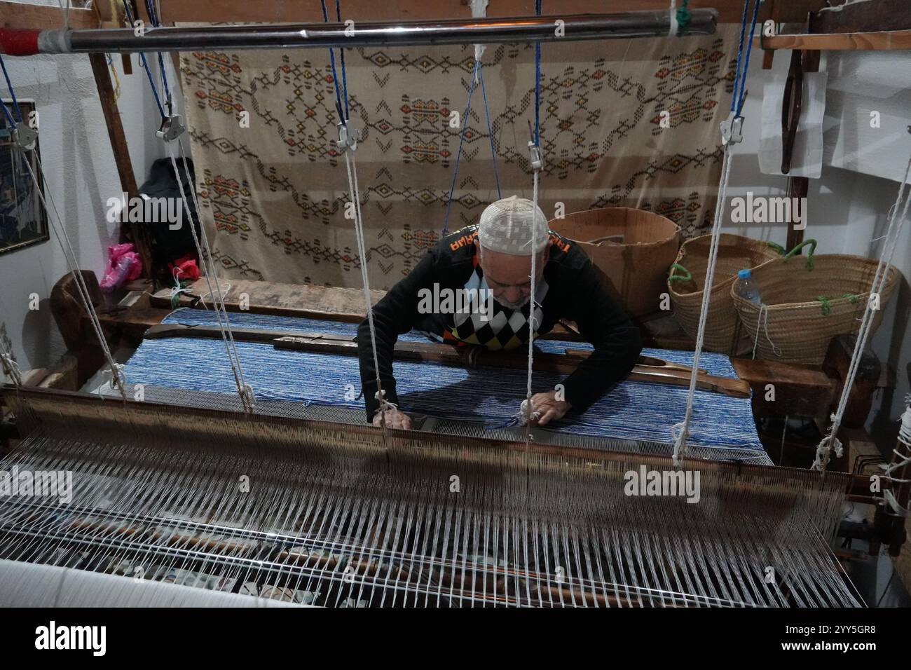 Weaver working on his loom in the Moroccan city of Chefchaouen, North ...