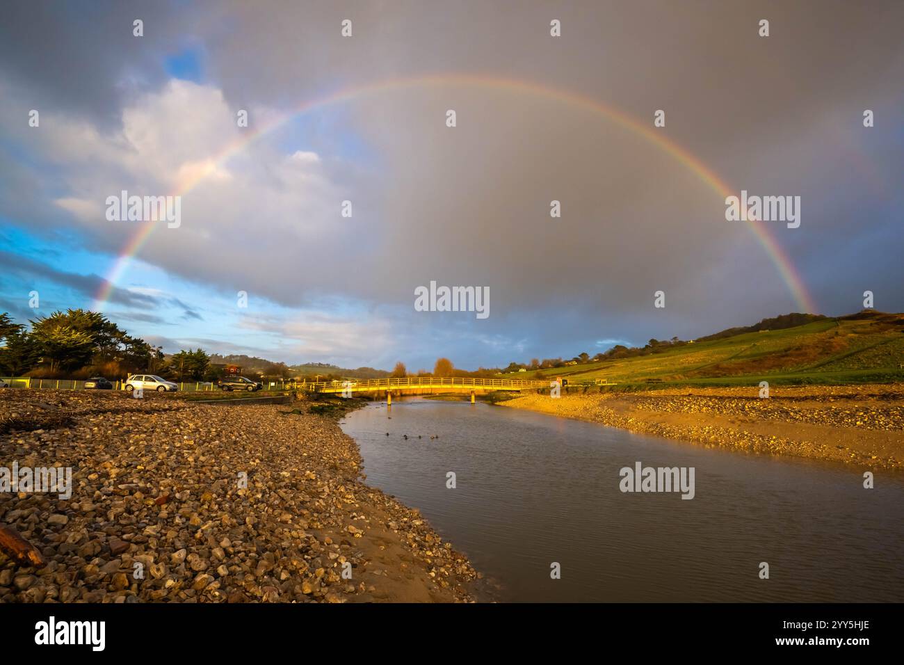 Charmouth, Dorset, UK. 19th December 2024. UK Weather. A rainbow arches ...