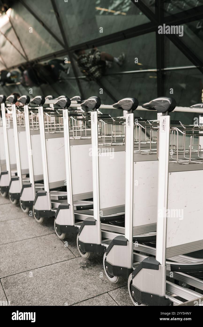 Luggage trolleys in airport terminal Stock Photo - Alamy