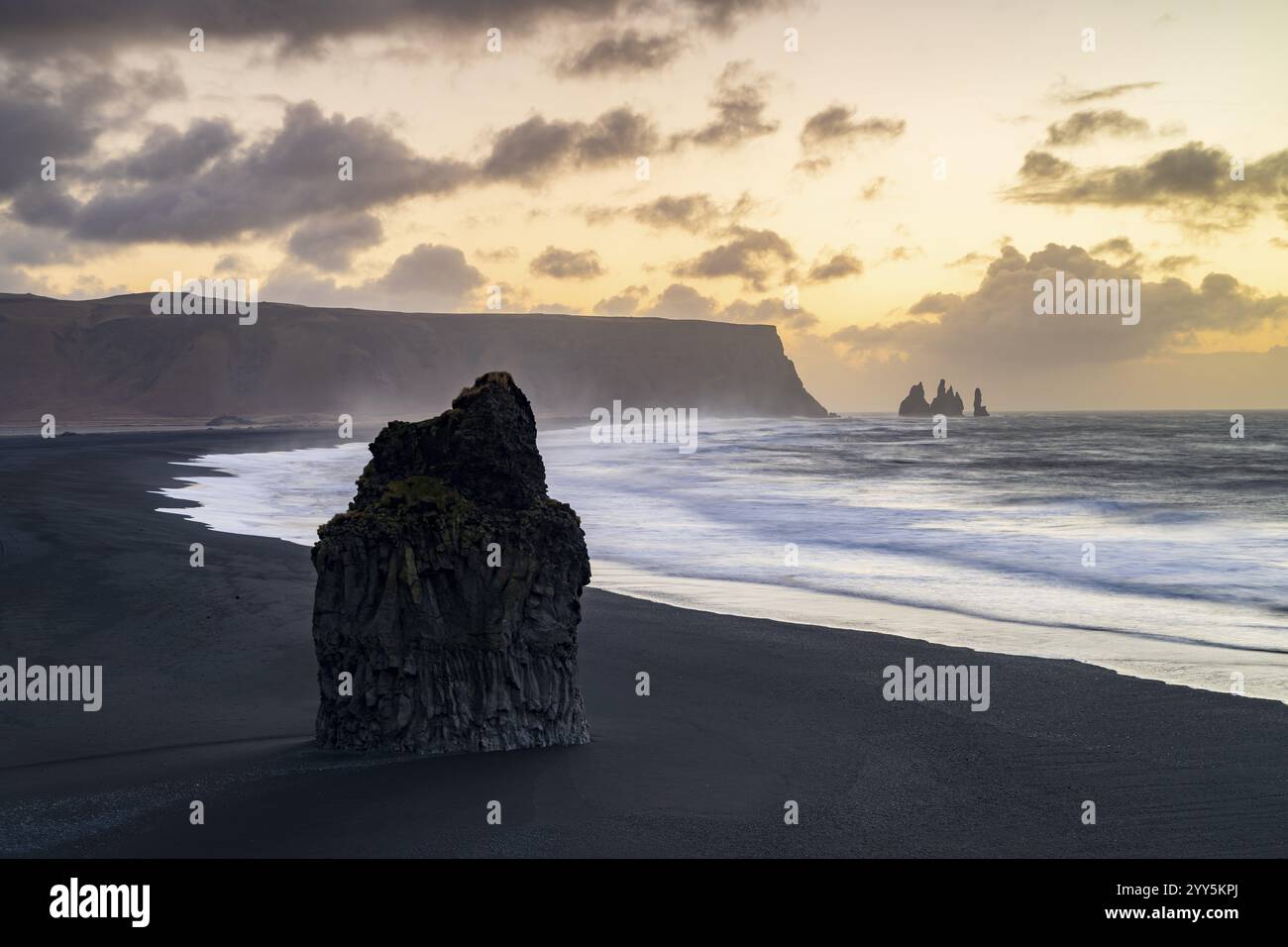 View from Cape Dyrholaey at sunrise, rock formations Reynisdrangar and ...