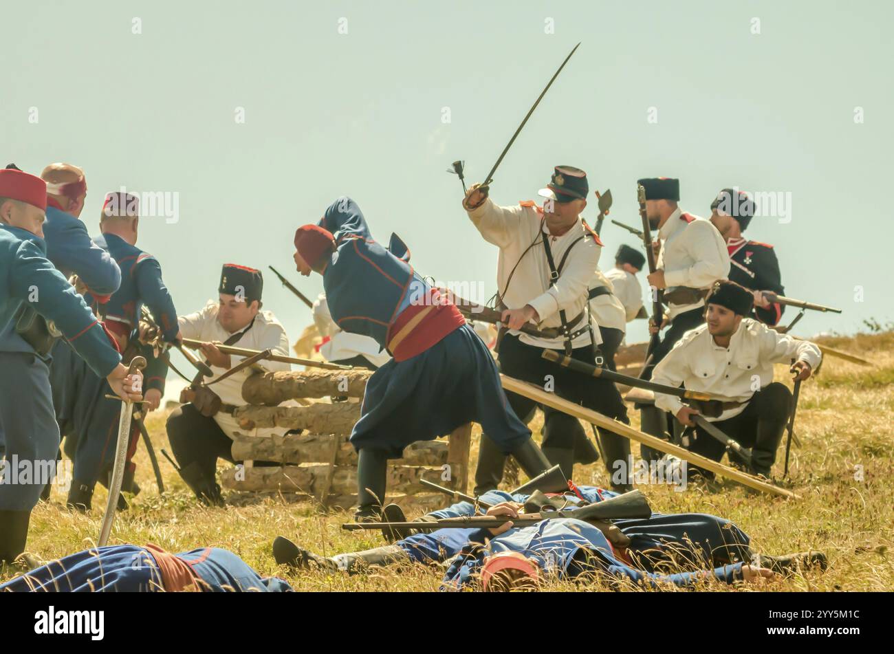 Engaged soldiers in combat with weapons during a historical reenactment ...