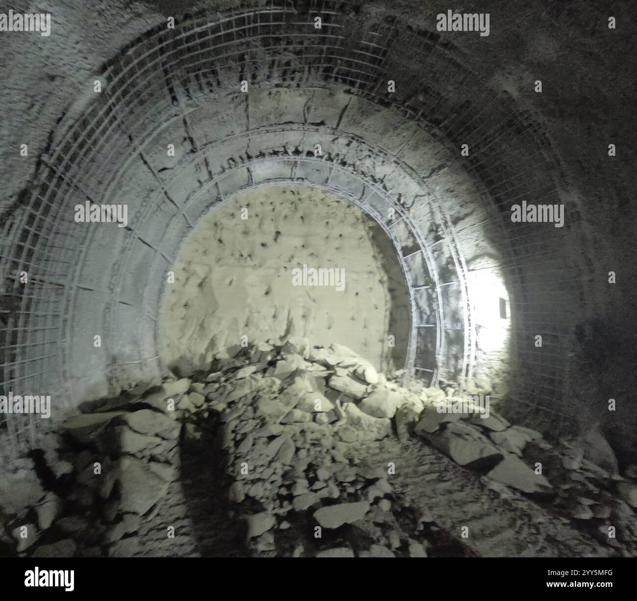 Underground tunnel with archway and rocks, indicating ongoing ...