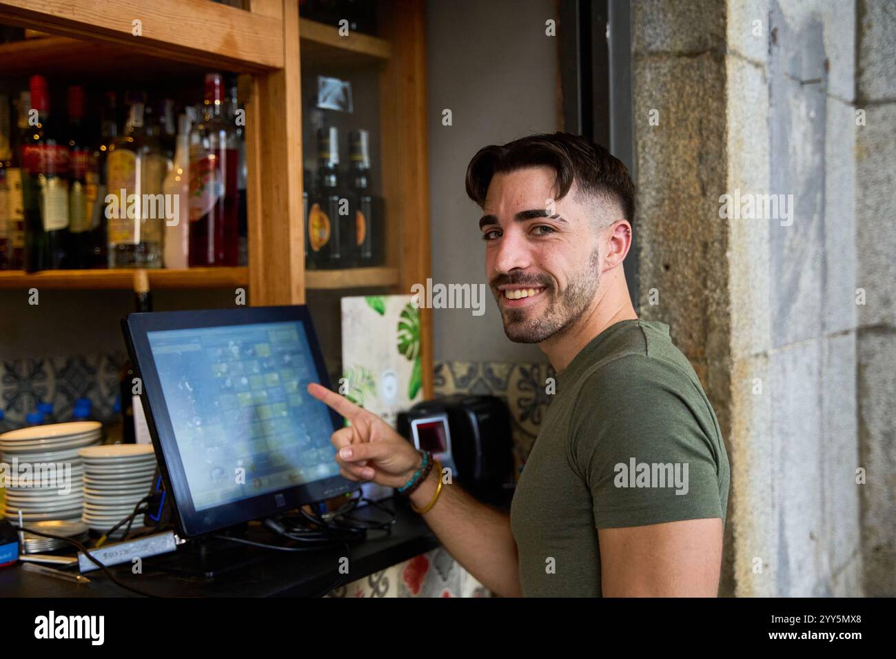 Man using touchscreen in rustic bar setting Stock Photo - Alamy