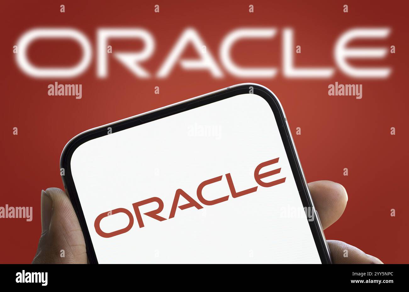 Oracle logo is diaplayed on smartphone. Oracle Corporation is an ...