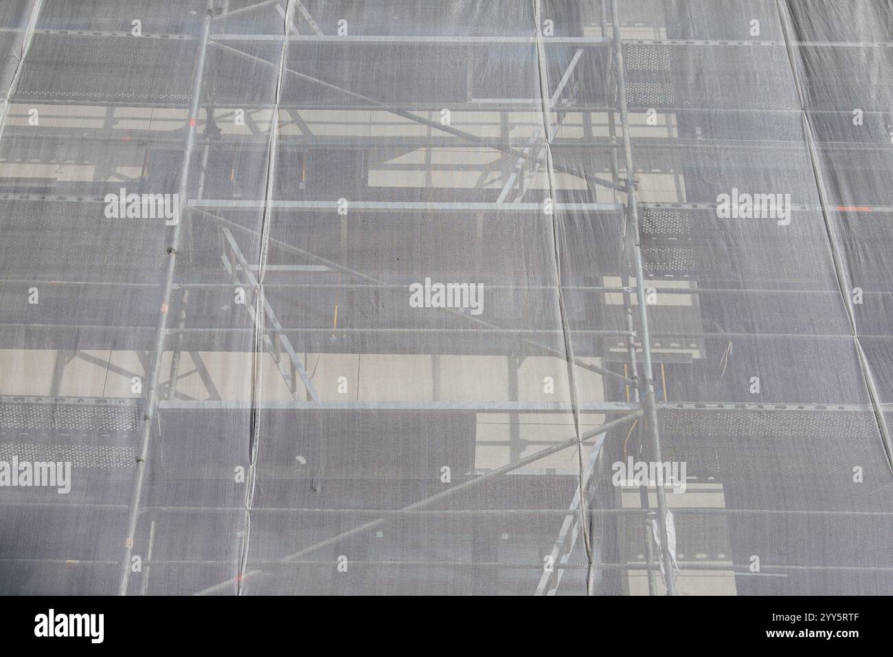 Net wrap or protective mesh covering scaffolding of multi-story ...