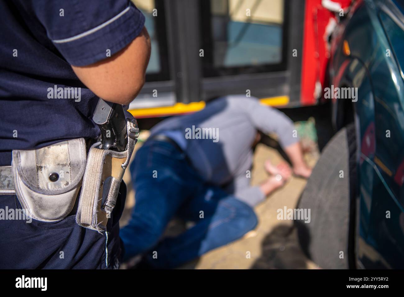 Behind the police officer, with gun belt. Close up detail on gun in the ...