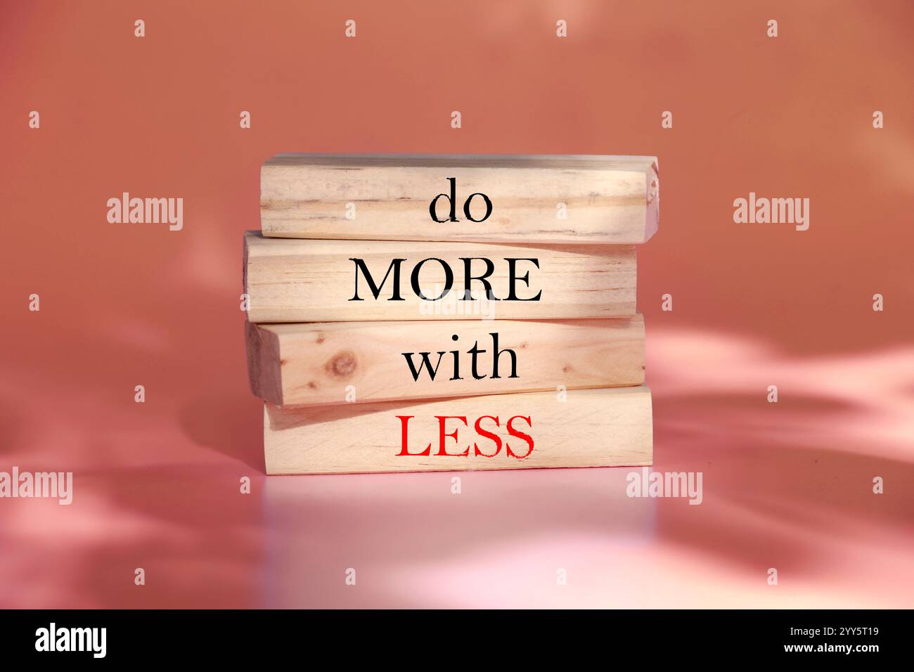 Do more with less symbol. Concept words Do more with less on wooden ...