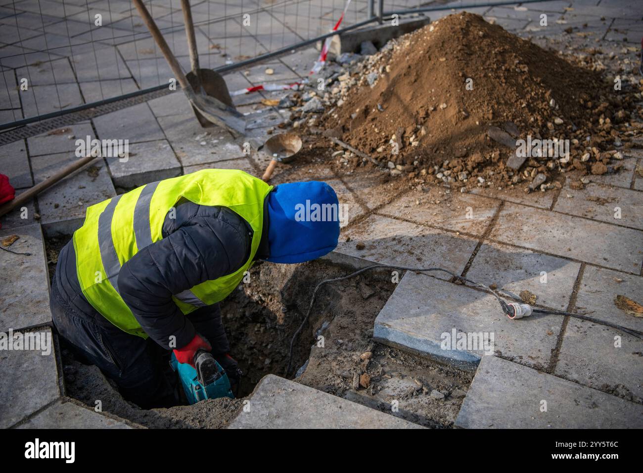 Worker man mason of road construction drilling cement concrete floor ...