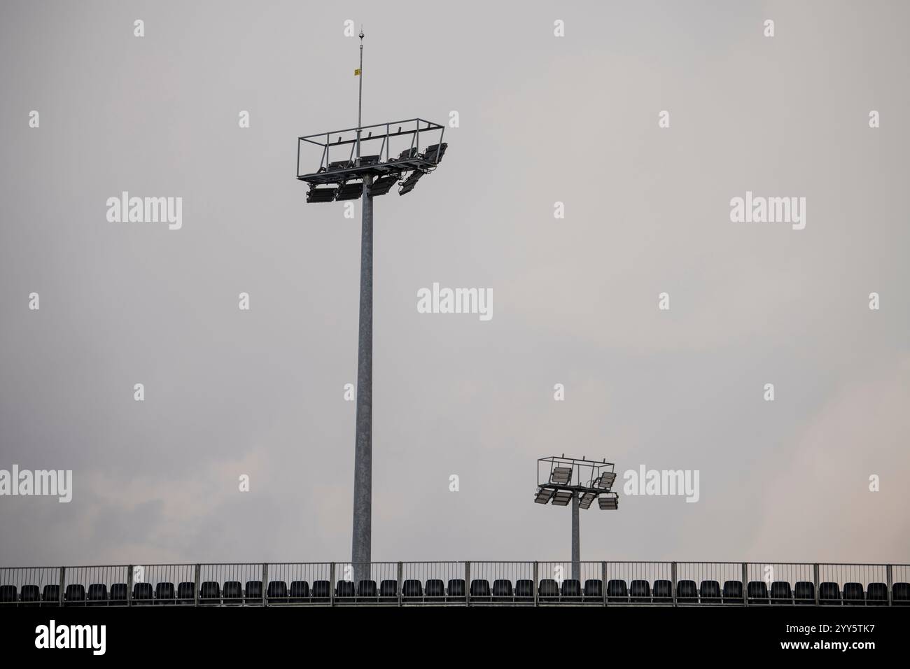 Empty stadium seats from behind. Stadium reflector lights in background ...