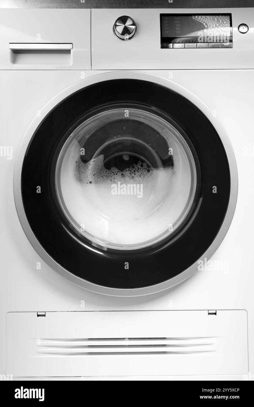 Washing machine with suds as background, closeup Stock Photo - Alamy