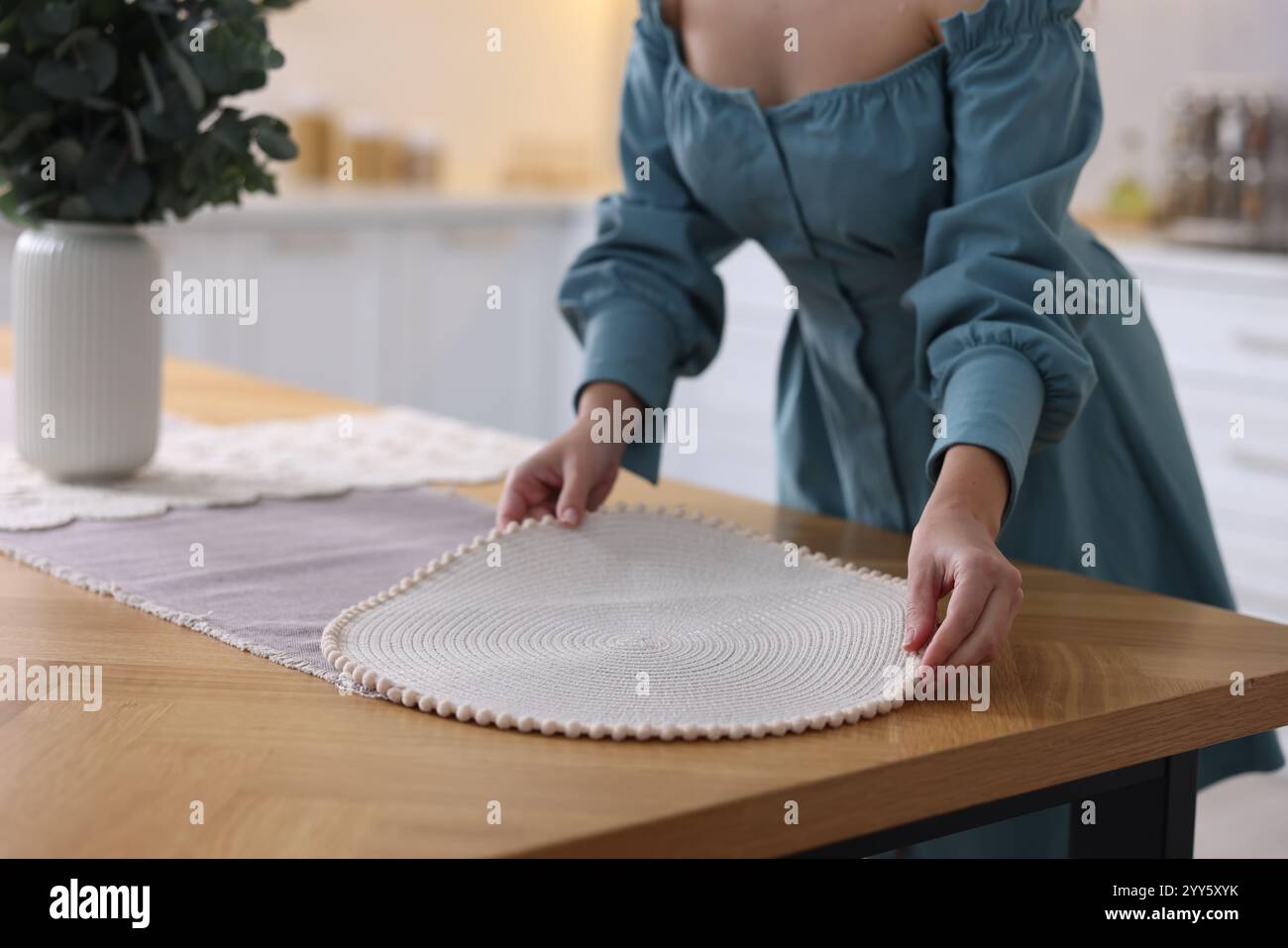 Woman setting table for dinner at home, closeup Stock Photo - Alamy