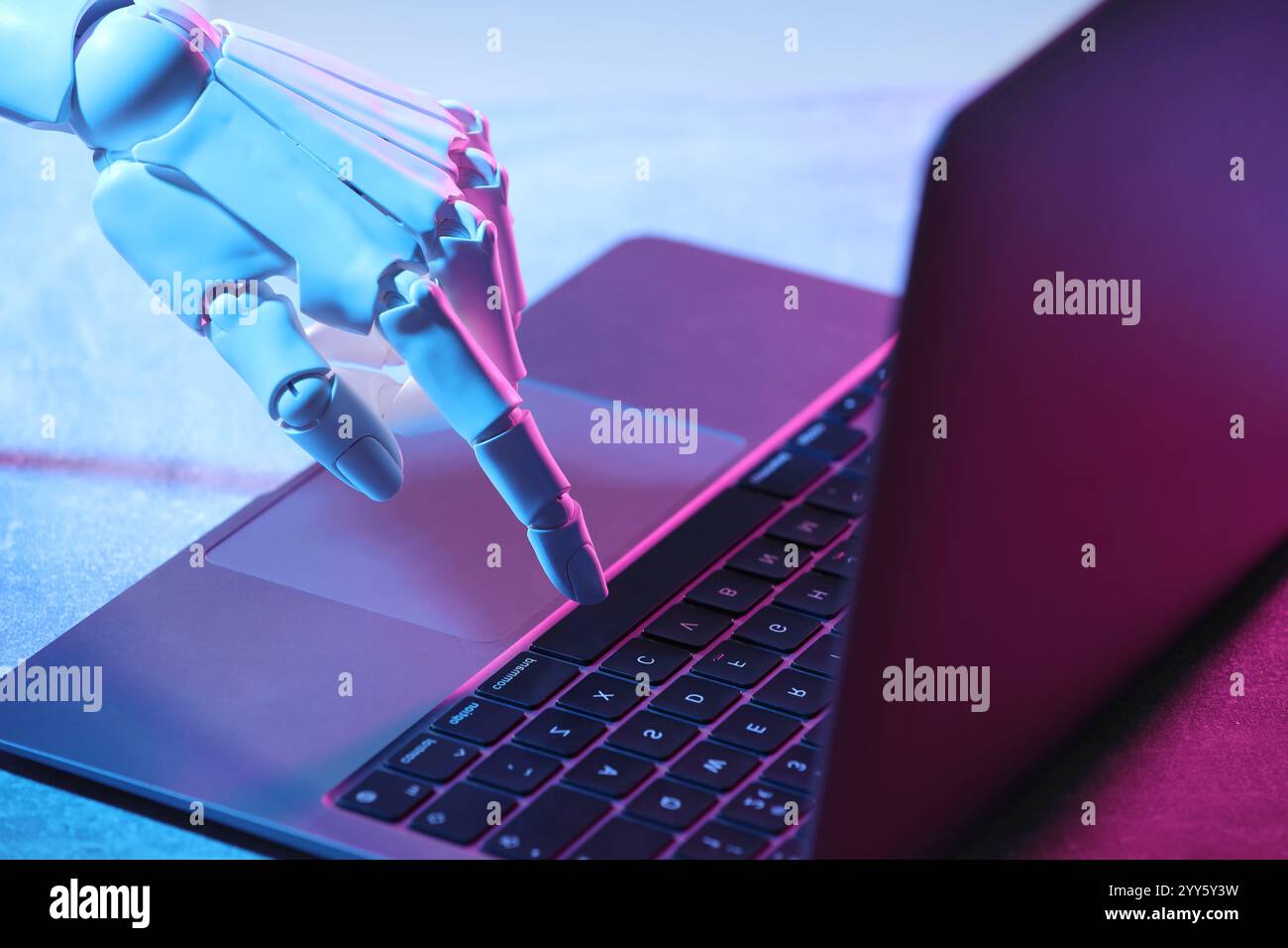 Artificial intelligence. Robot hand using laptop on table in neon ...