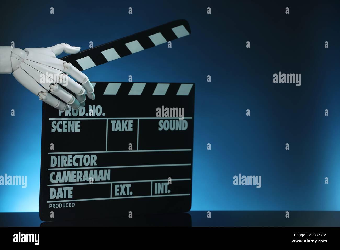 Artificial intelligence. Robot hand with clapper against dark blue ...