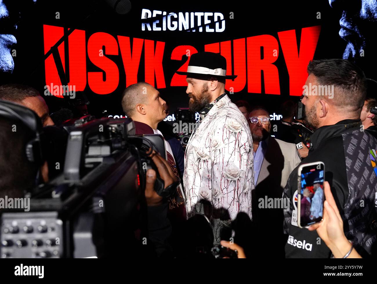 Oleksandr Usyk (left) and Tyson Fury face off during a press conference ...