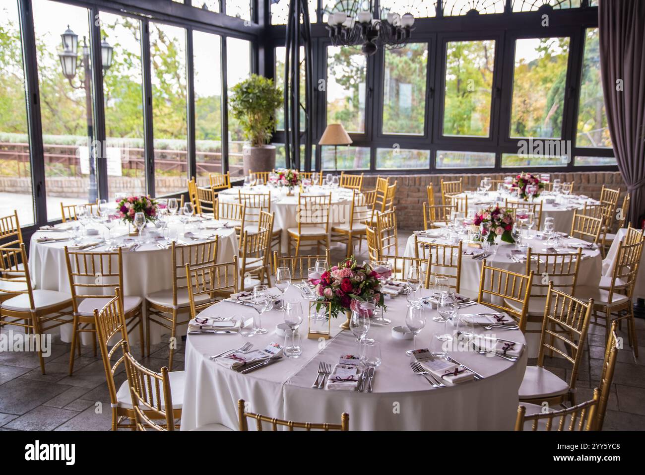 Luxury wedding banquet reception dinning table setup. The chairs and ...