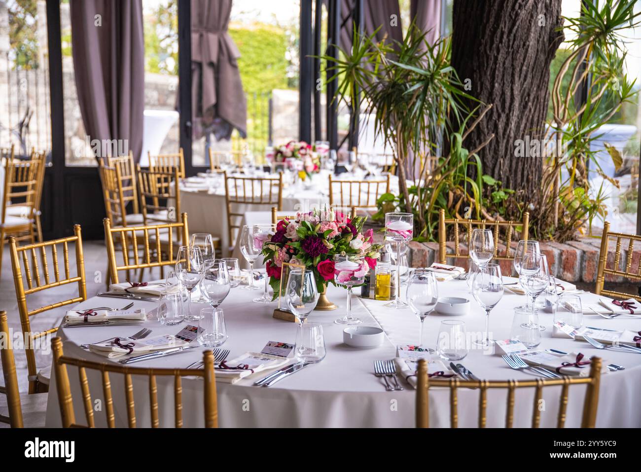 Luxury wedding banquet reception dinning table setup. The chairs and ...