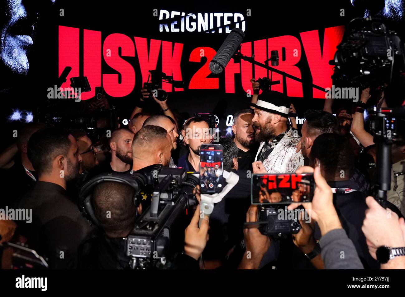 Oleksandr Usyk (left) and Tyson Fury face off during a press conference ...