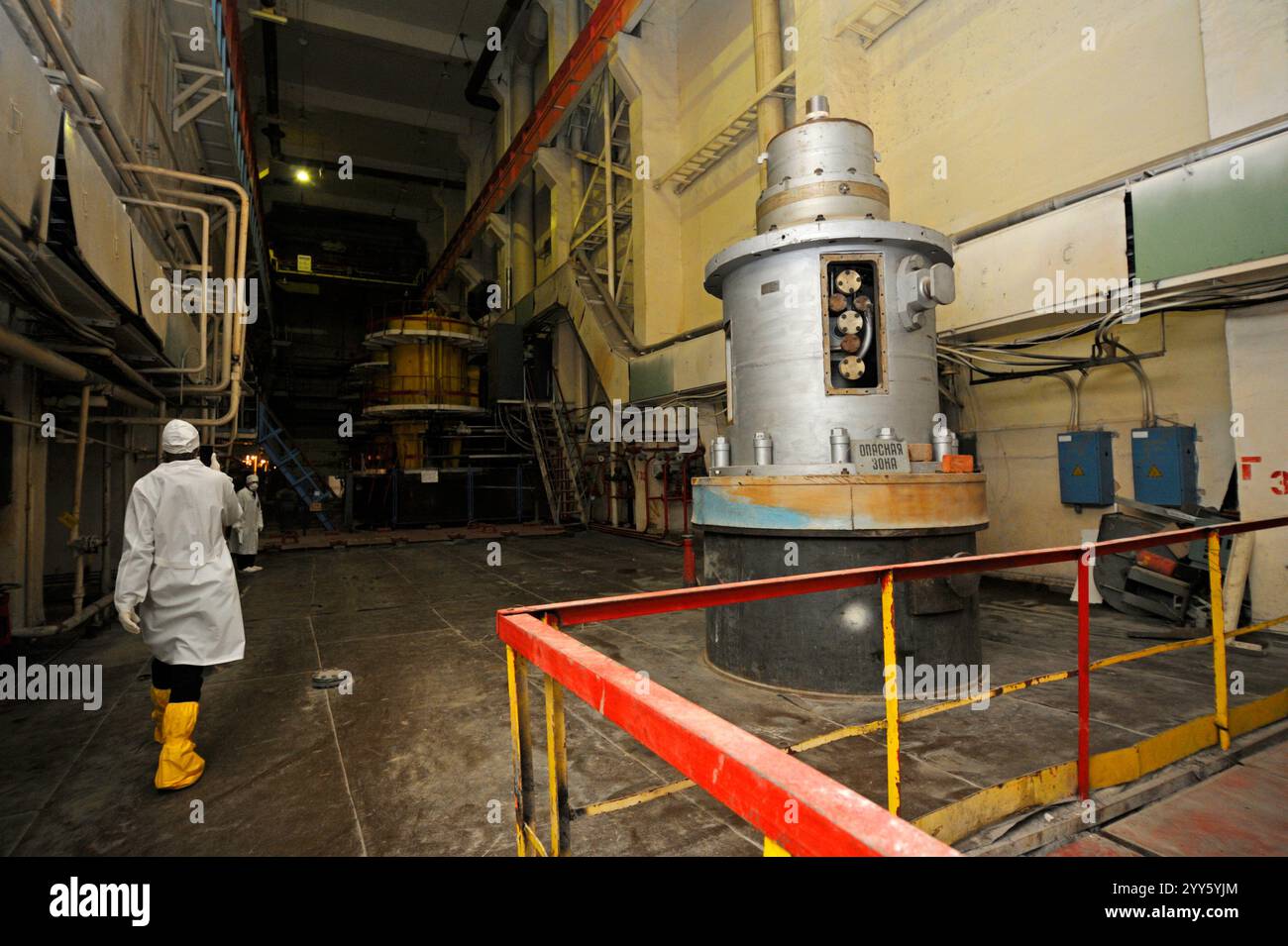 Group of tourists and journalists visiting the hall of pumping station ...