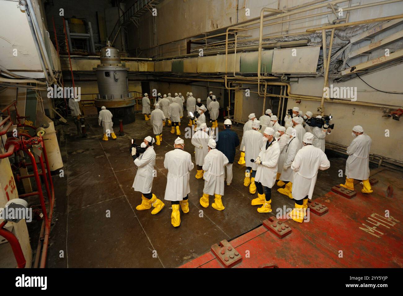 Group of tourists and journalists visiting the hall of pumping station ...