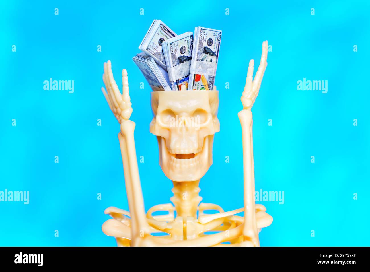 Skeleton model with arms raised, displaying stacks of money inside its ...