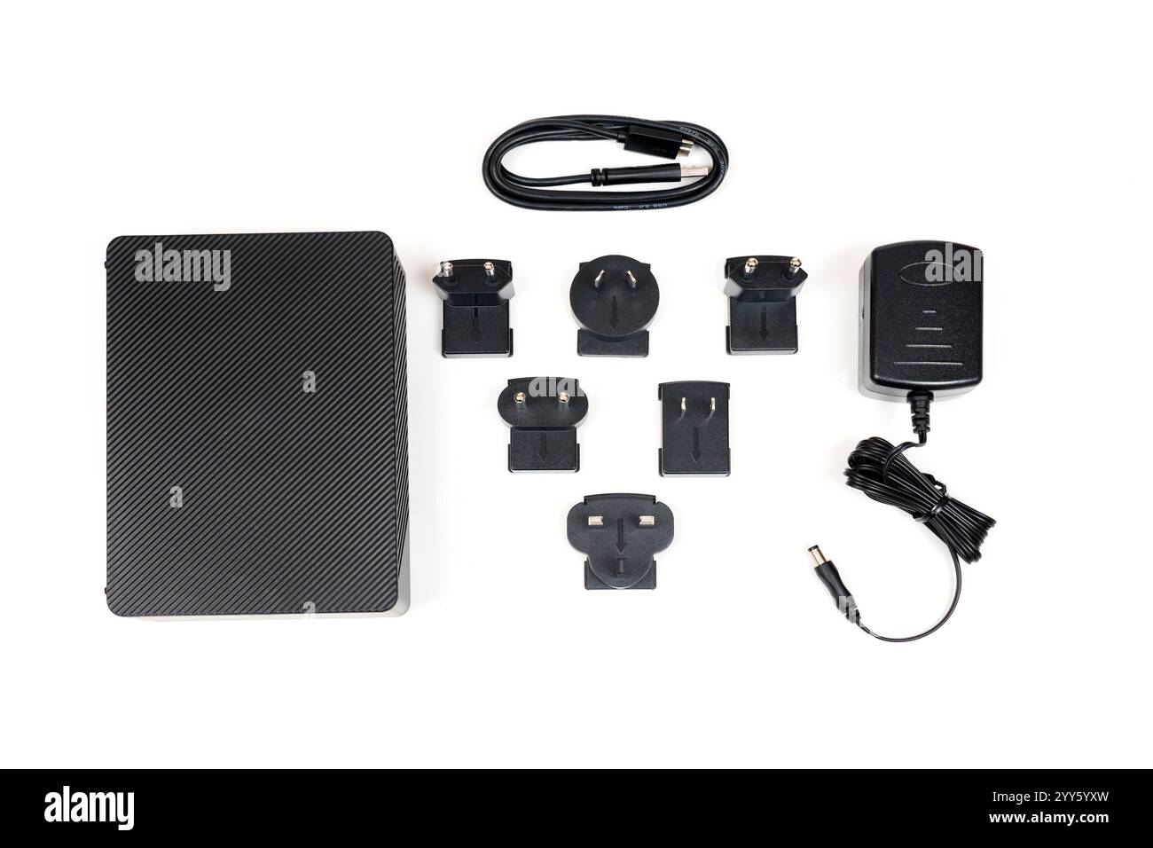 External hard drive surrounded by various charging connectors for ...