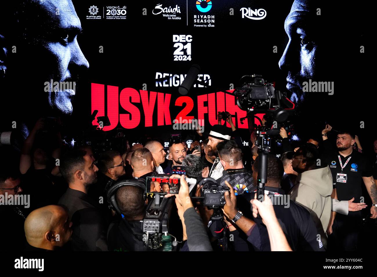 Oleksandr Usyk (left) and Tyson Fury face off during a press conference ...