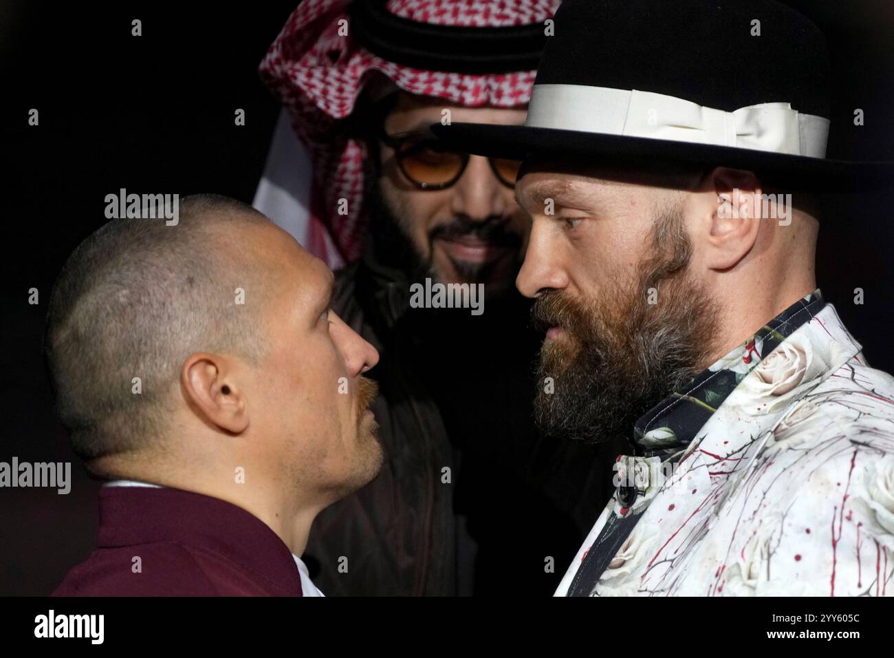 Boxer Tyson Fury, right, and Oleksandr Usyk, left, face off under the ...