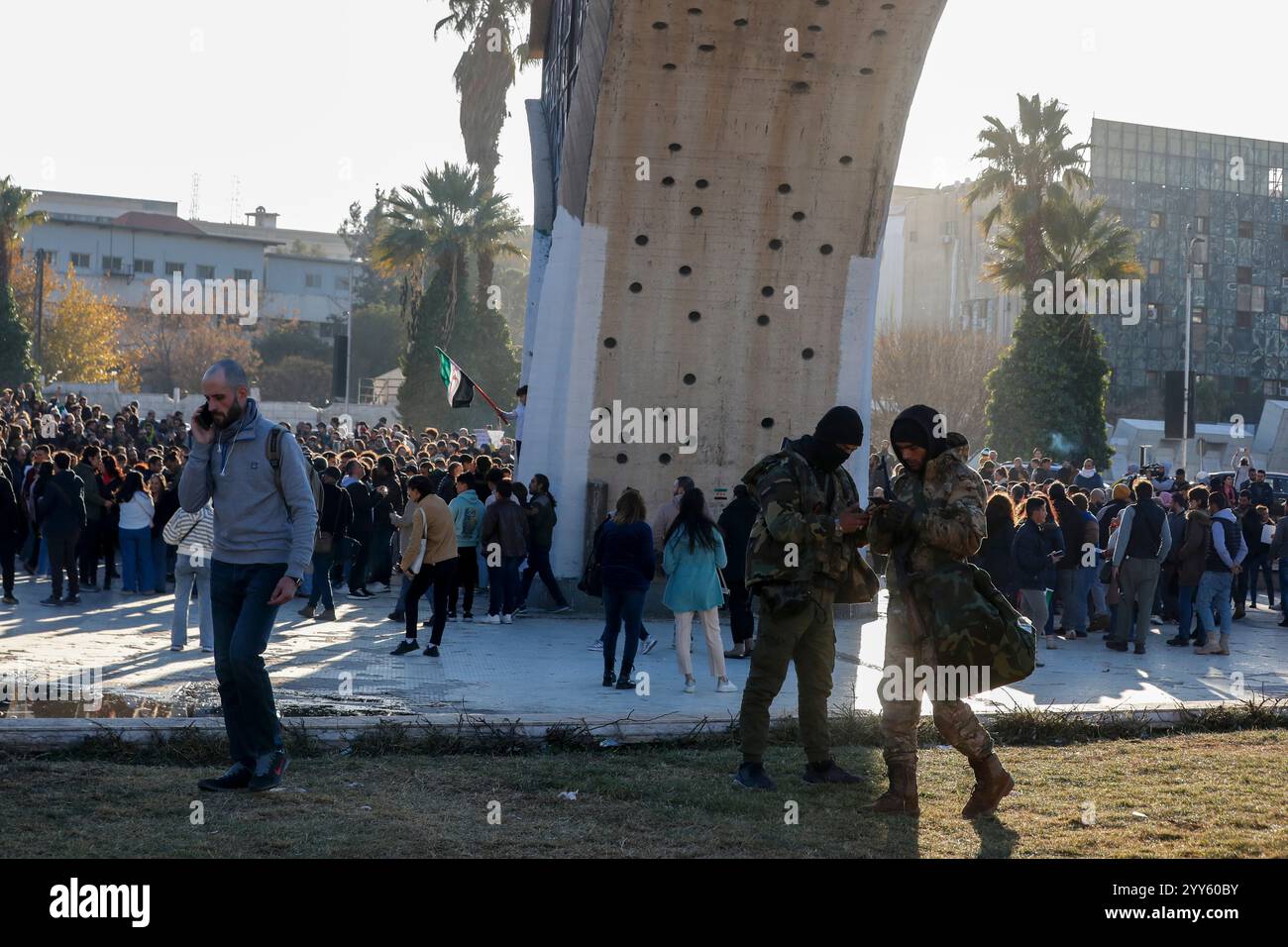 Two Syrian fighters stand guard as activists gather at the Umayyad ...